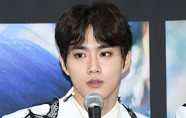 Suho Pakai Syal Mewah di Bandara Menuju MAMA, Netter: Gaya Oppa 90an